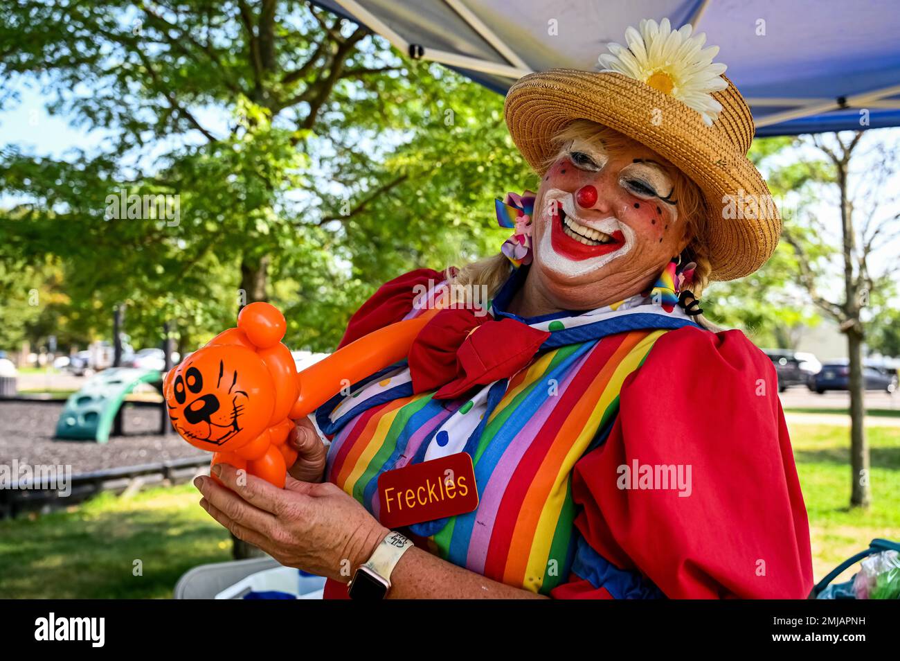 “Freckles the Clown” creates a balloon animal during the 305th AMW ...