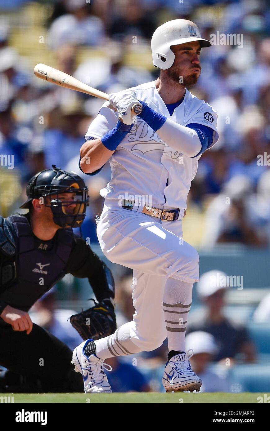 Los Angeles Dodgers' Cody Bellinger follows through on a swing for a ...