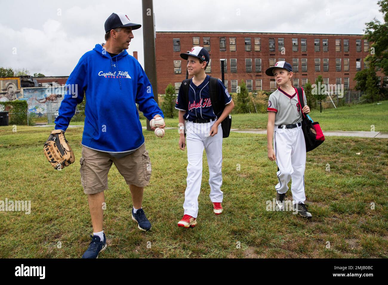 David Fox, from left, walks with his sons Dewey and Jimmy to a nearby ...
