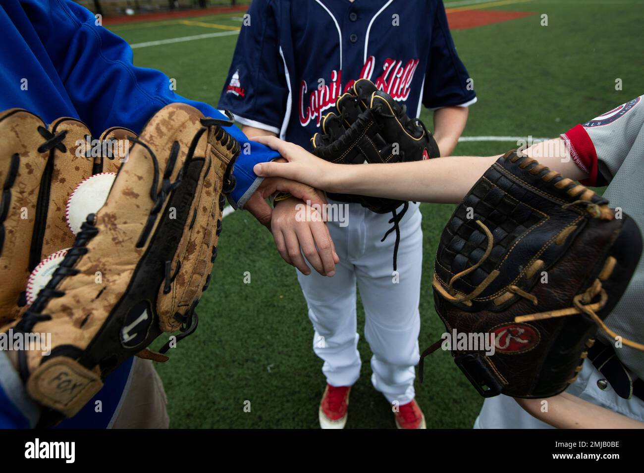 David Fox, from left, with his sons Dewey and Jimmy put their hands ...