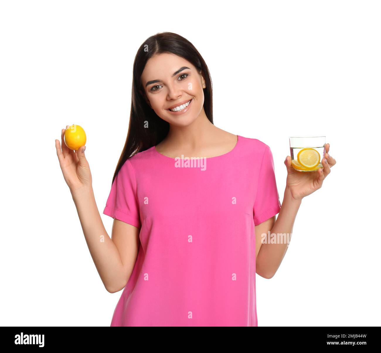 Beautiful young woman with tasty lemon water and fresh fruit on white ...