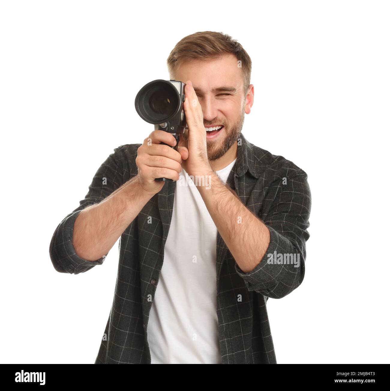 Young man using vintage video camera on white background Stock Photo ...