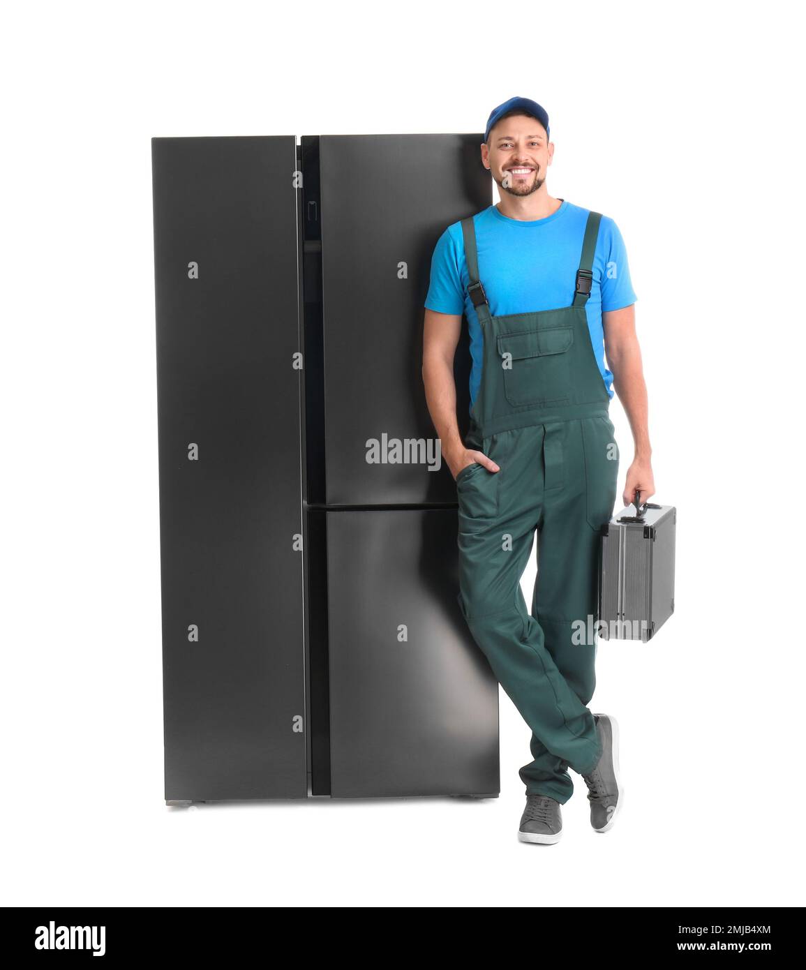 Male technician with tool box near refrigerator on white background ...