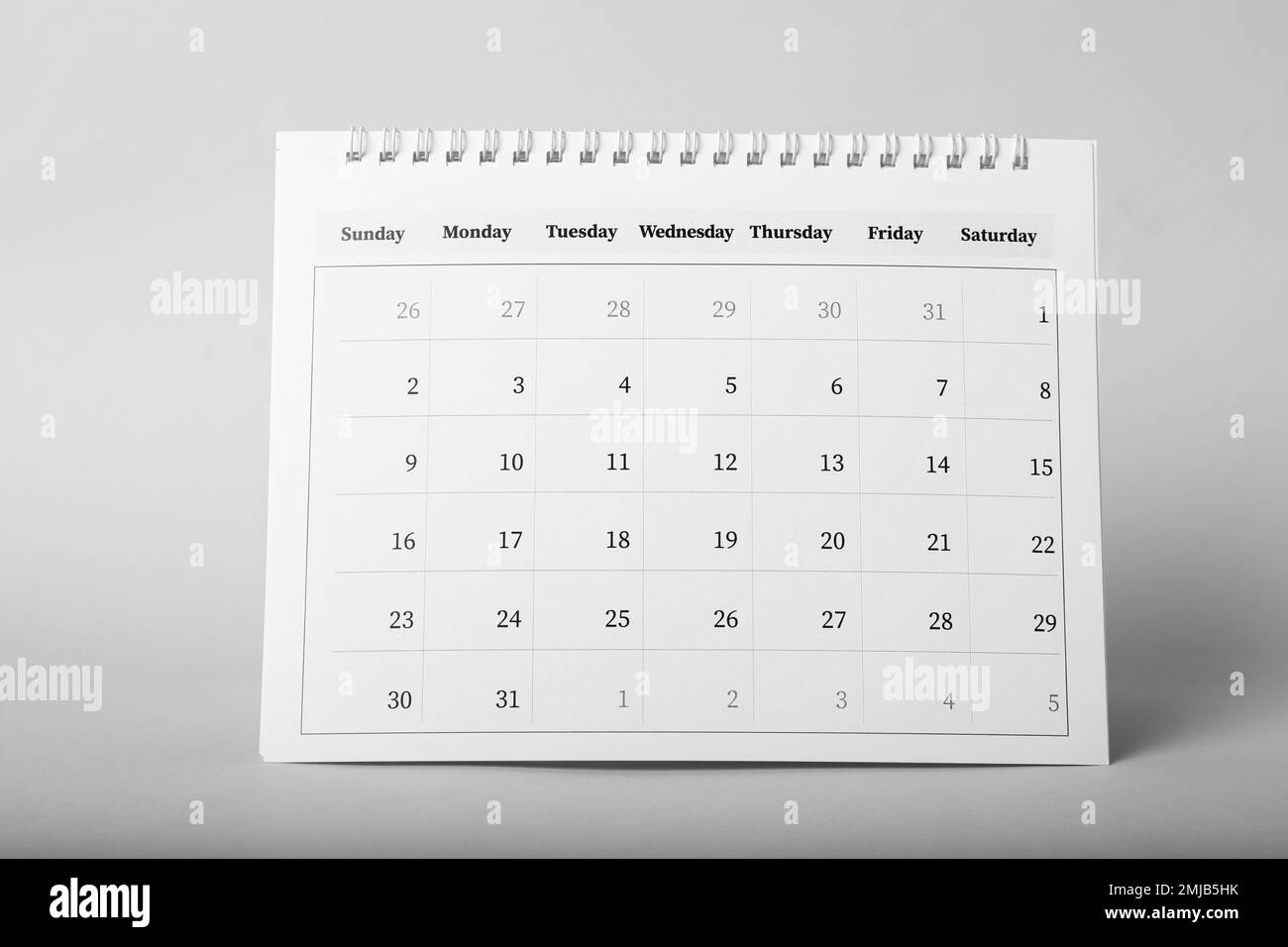 Paper calendar on grey background. Planning concept Stock Photo - Alamy
