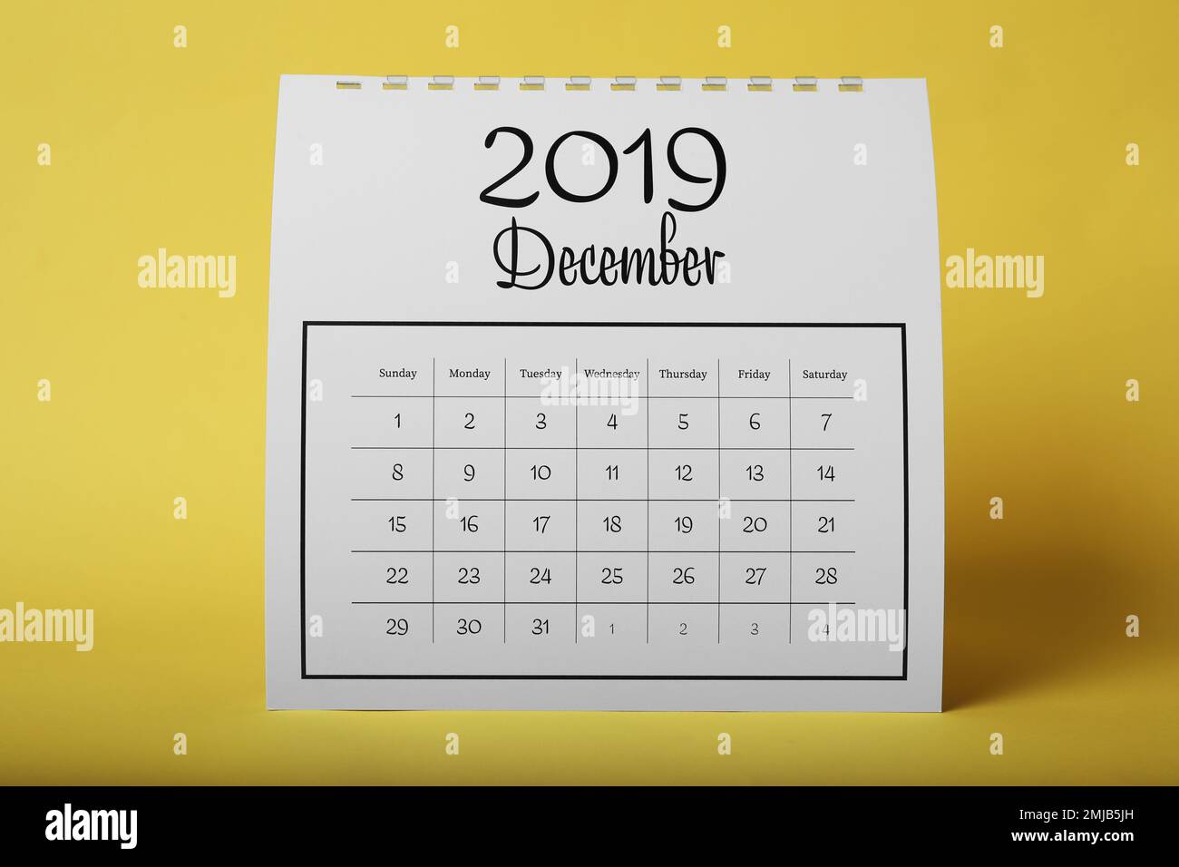 Paper calendar on yellow background. Planning concept Stock Photo - Alamy