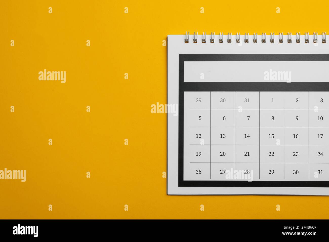 Paper calendar on yellow background, top view. Space for text Stock ...