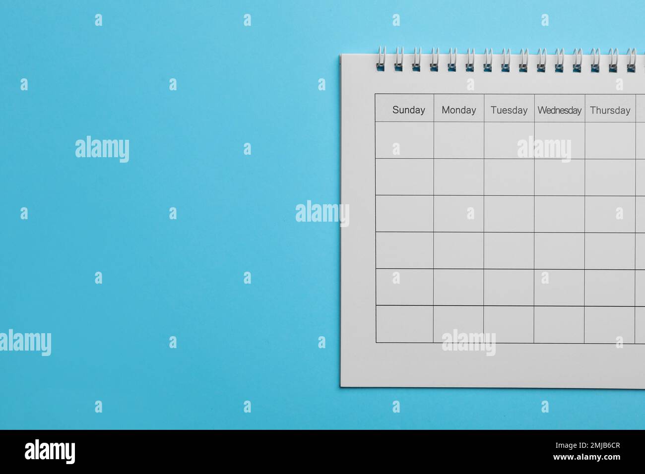 Blank calendar on light blue background, top view. Space for text Stock ...