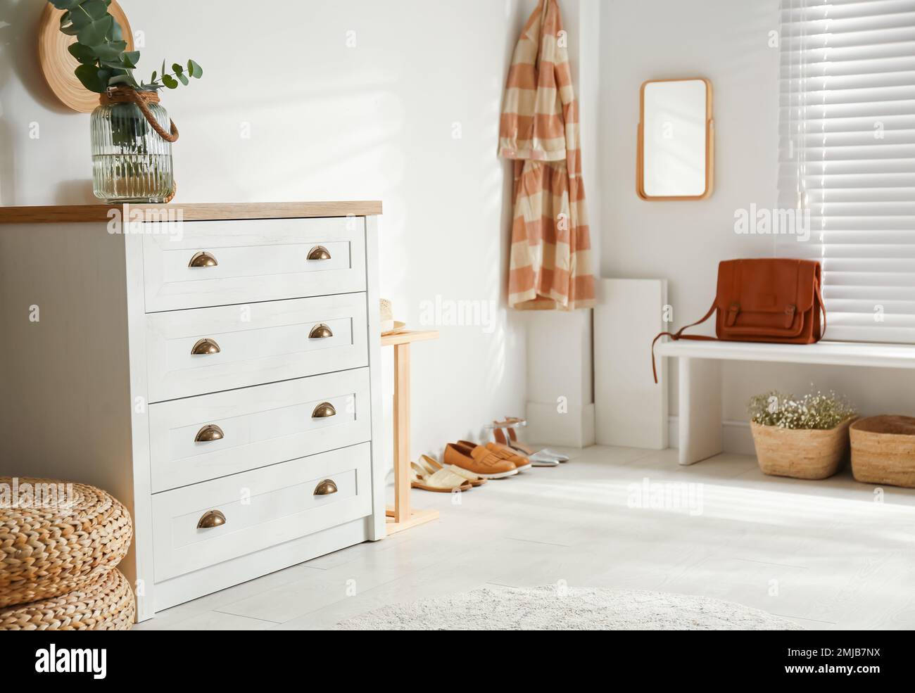 Chest of drawers in stylish room interior Stock Photo - Alamy