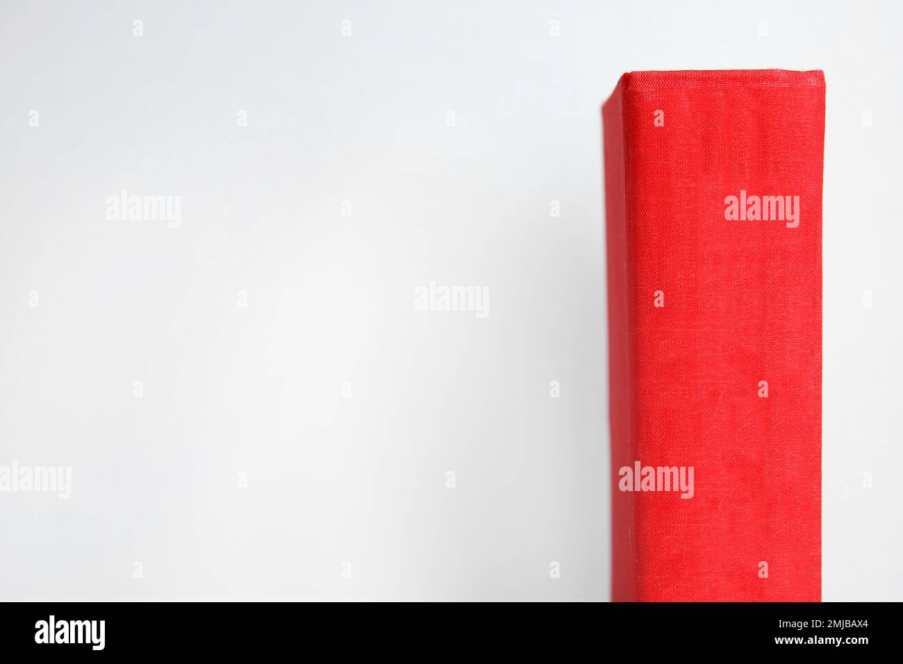 Old red book on light background, space for text Stock Photo - Alamy