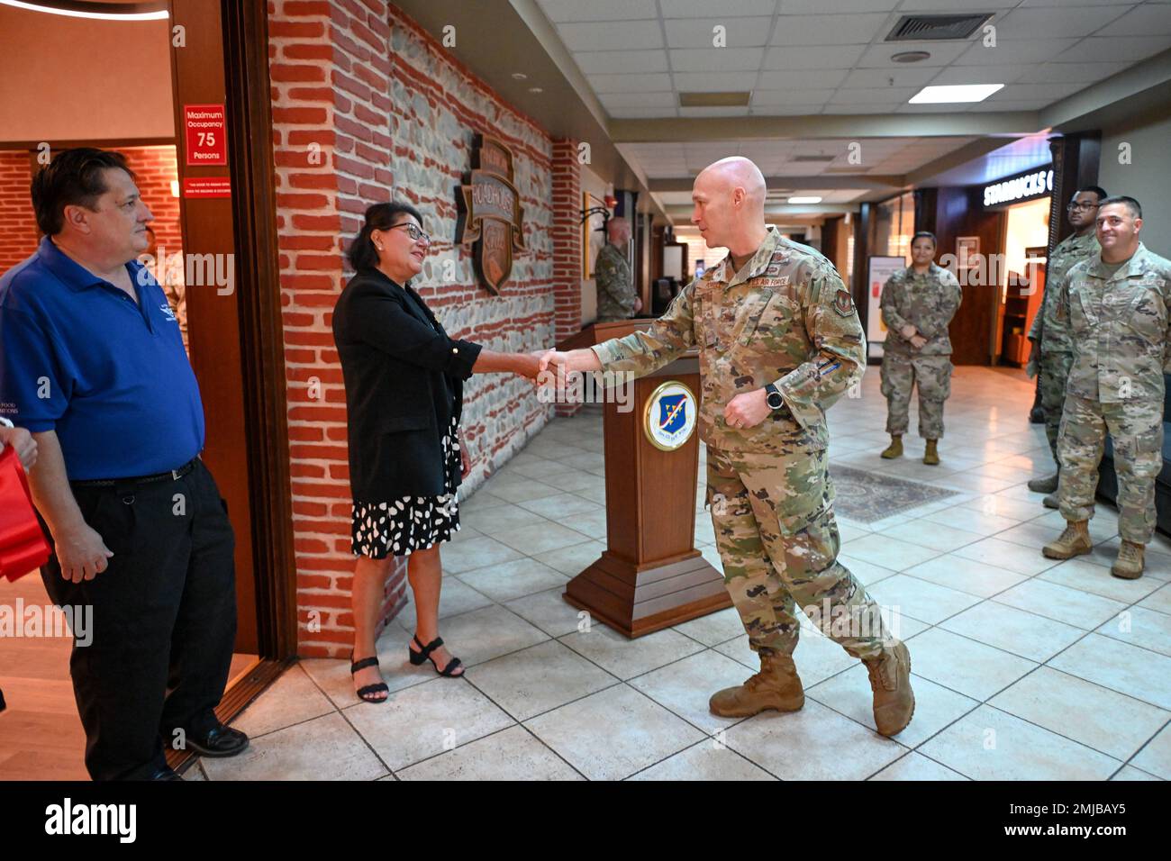 Col. Calvin Powell, 39th Air Base Wing commander, coins Sally Truhitte, 39th Force Support ...