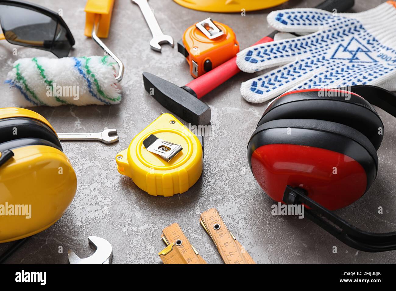 Many different construction tools on grey marble table Stock Photo - Alamy