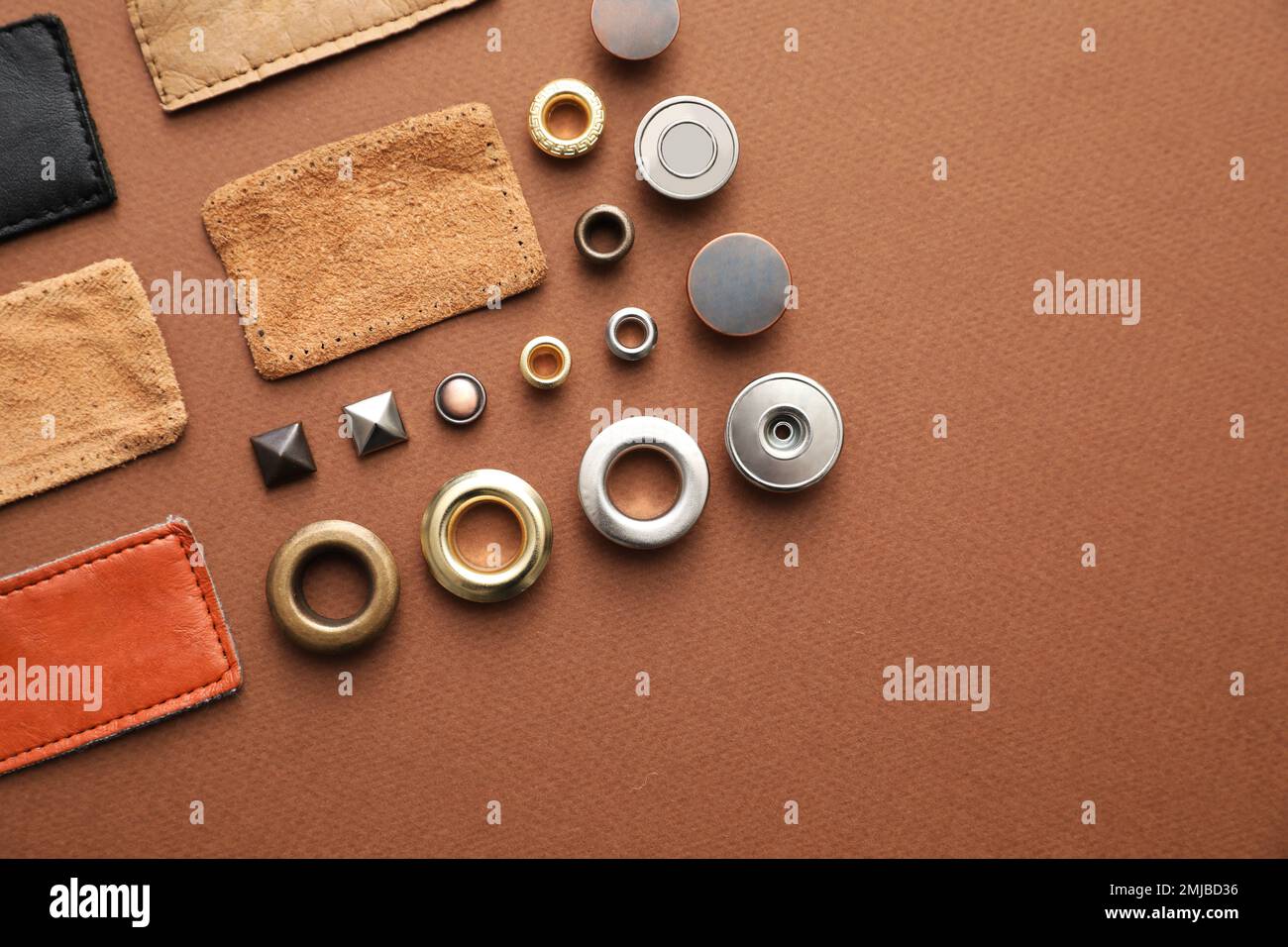 Flat lay composition with garment accessories for jeans on brown ...