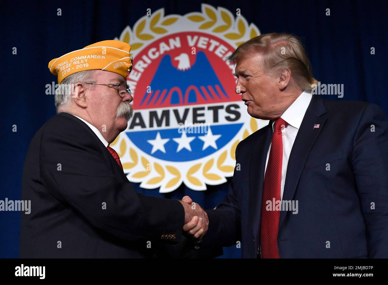 President Donald Trump greets AMVETS national commander Rege Riley at ...