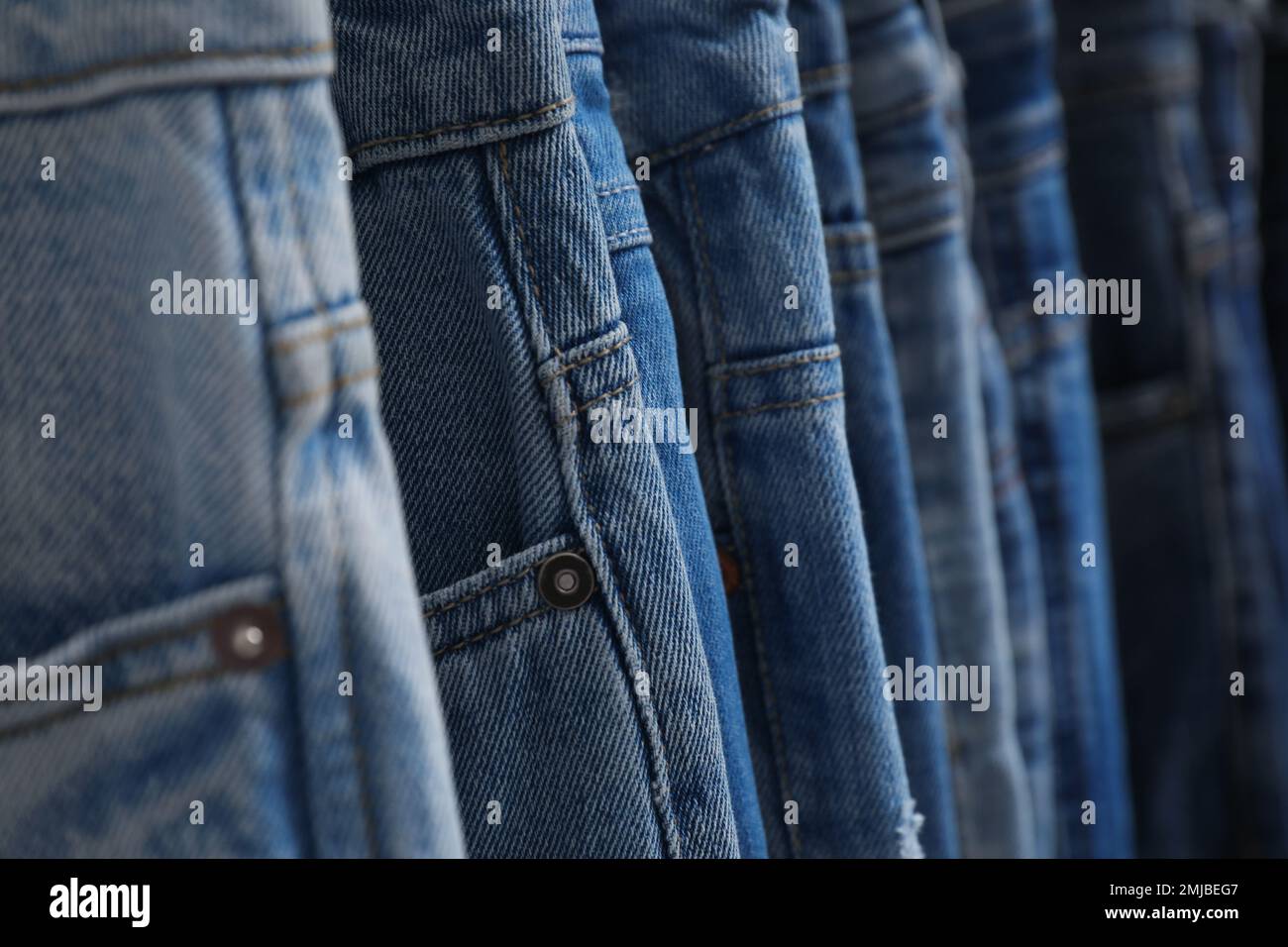 Different stylish blue jeans as background, closeup Stock Photo - Alamy