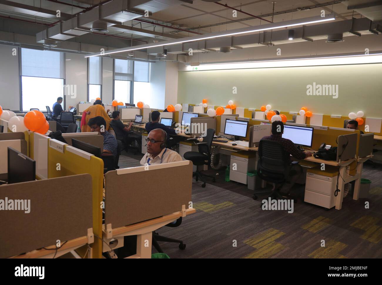 Indian employees work inside Amazon's newly inaugurated campus building ...