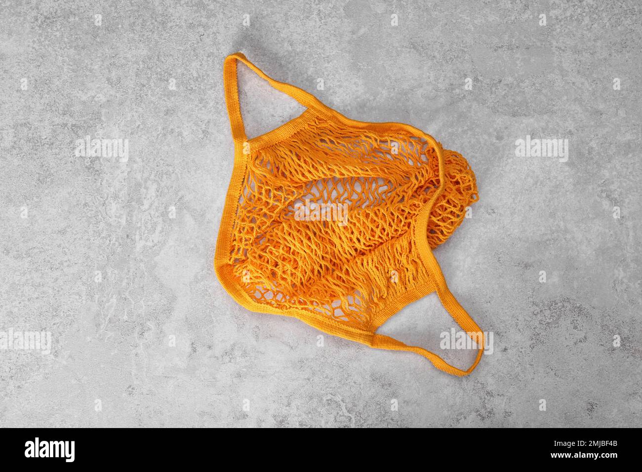 Orange net bag on light grey table, top view Stock Photo - Alamy