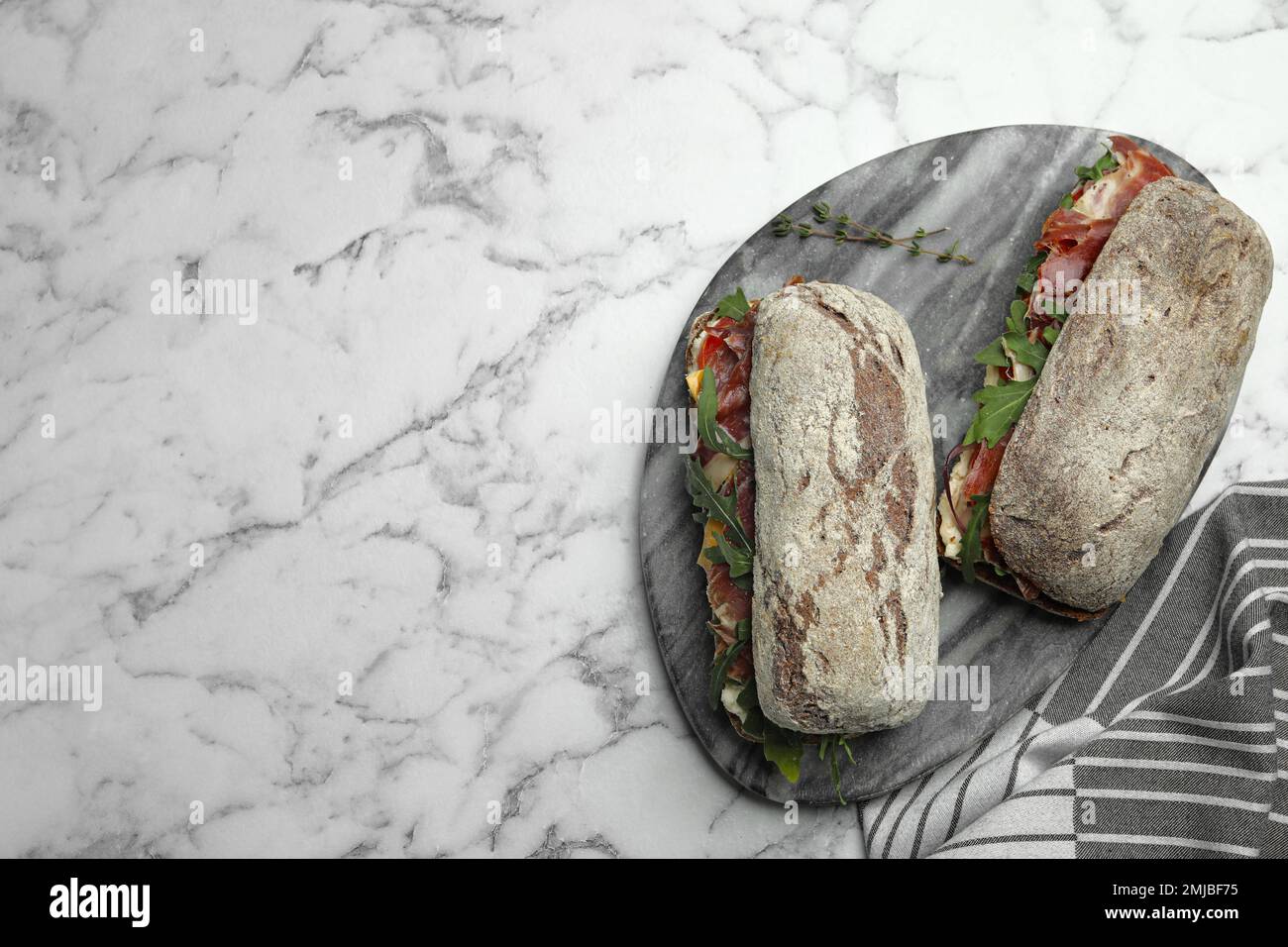 Delicious sandwiches with fresh vegetables and prosciutto on white ...