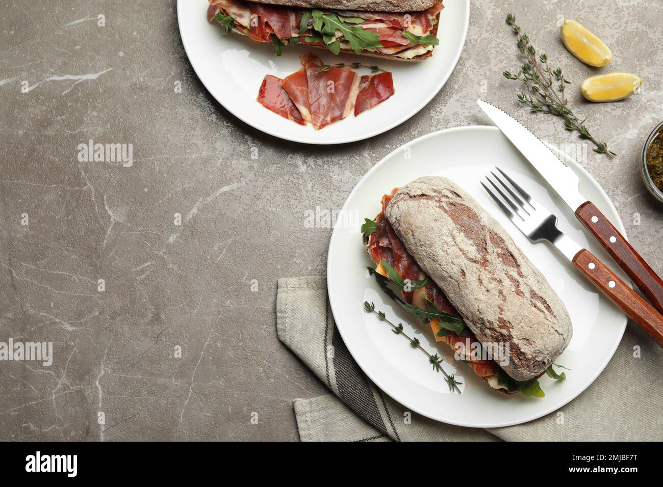 Flat lay composition with delicious sandwich on marble table. Space for ...