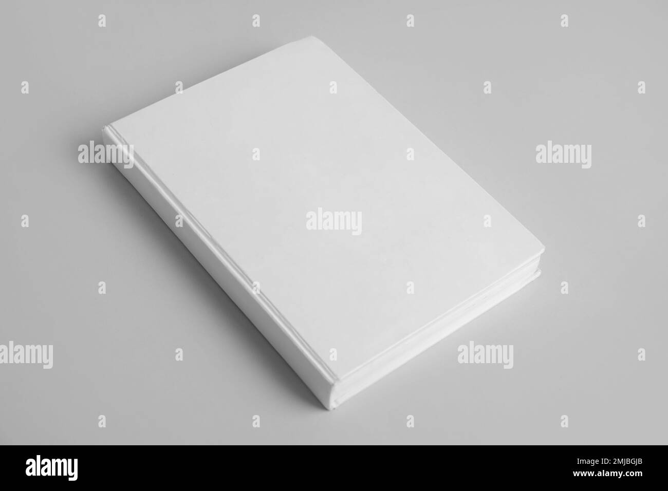 Book with blank cover on grey background Stock Photo - Alamy