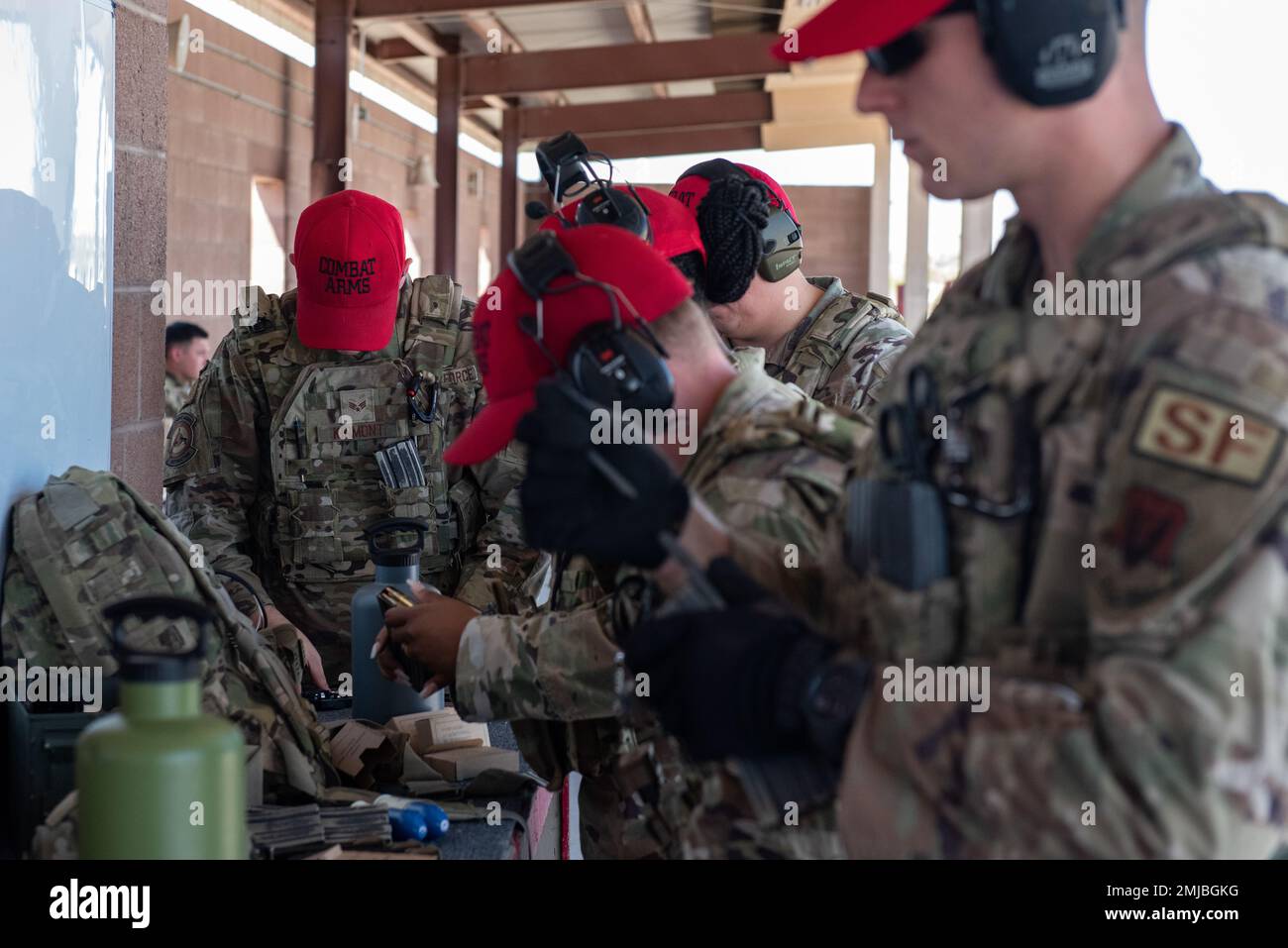 Combat Arms instructors assigned to the 99th Security Forces Squadron load their magazines ...