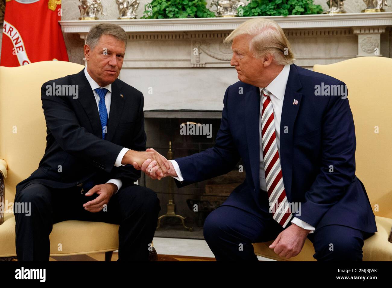 President Donald Trump and Romanian President Klaus Iohannis shake ...