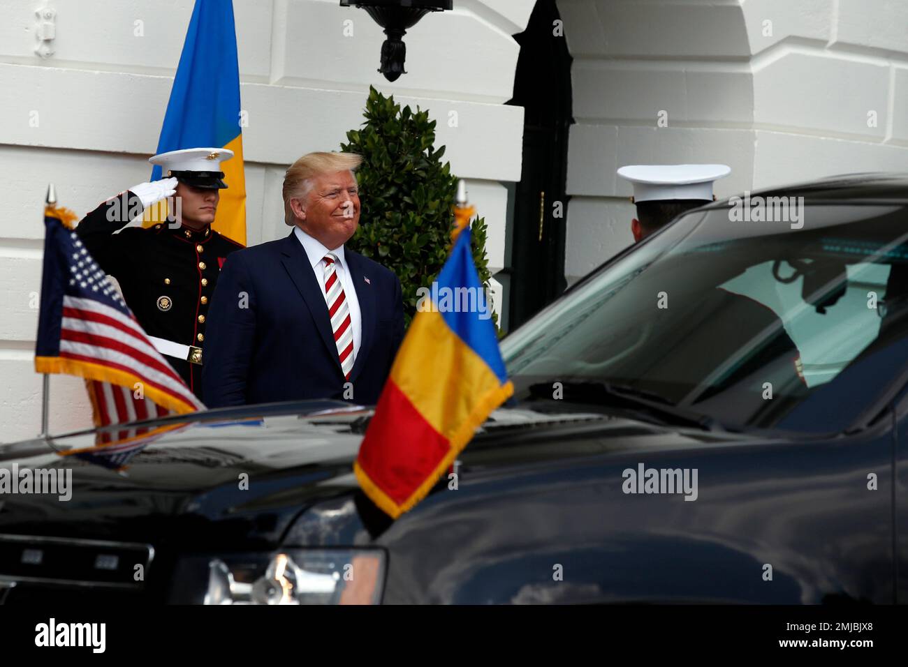 President Donald Trump waits to greet Romanian President Klaus Iohannis ...