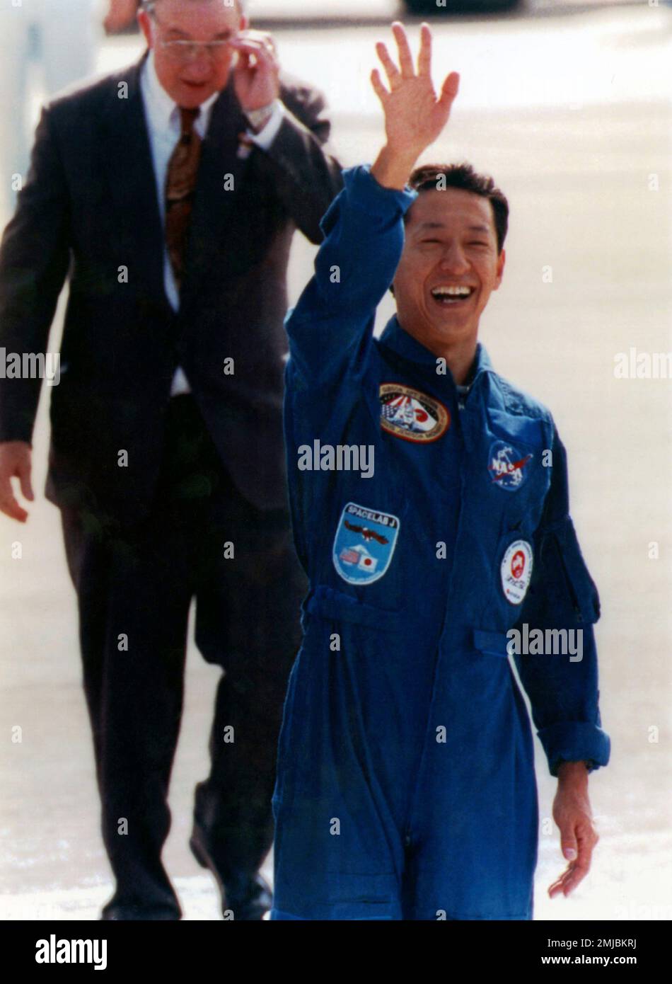 Japanese astronaut Mamoru Mohri, from Yoichi, Hokkaido, Japan, waves to ...