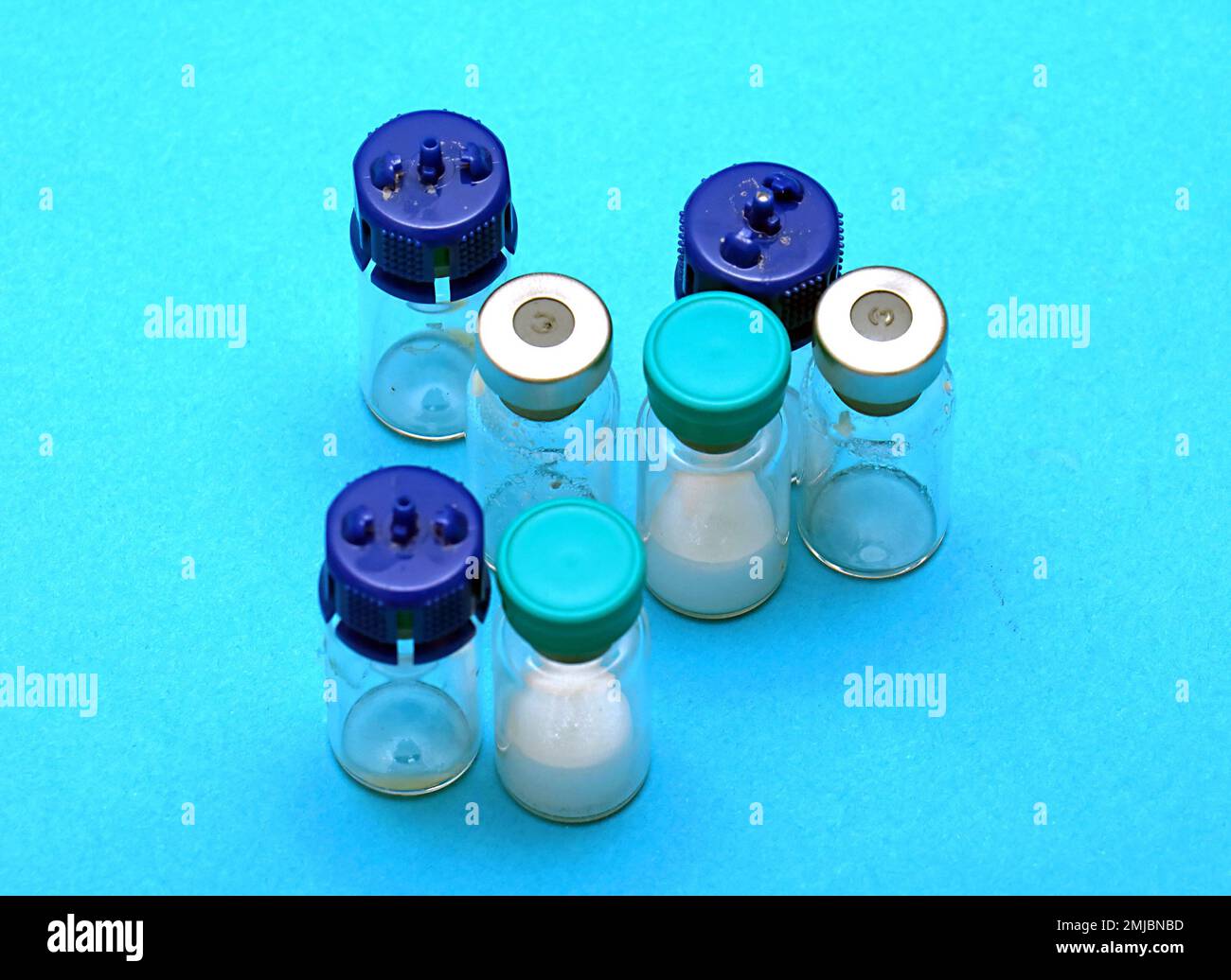 Glass injection medicine ampules vials isolated on blue background ...