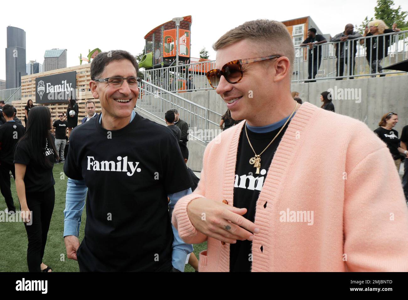 Hip-hop artist Macklemore, right, talks with Seattle Sounders MLS ...