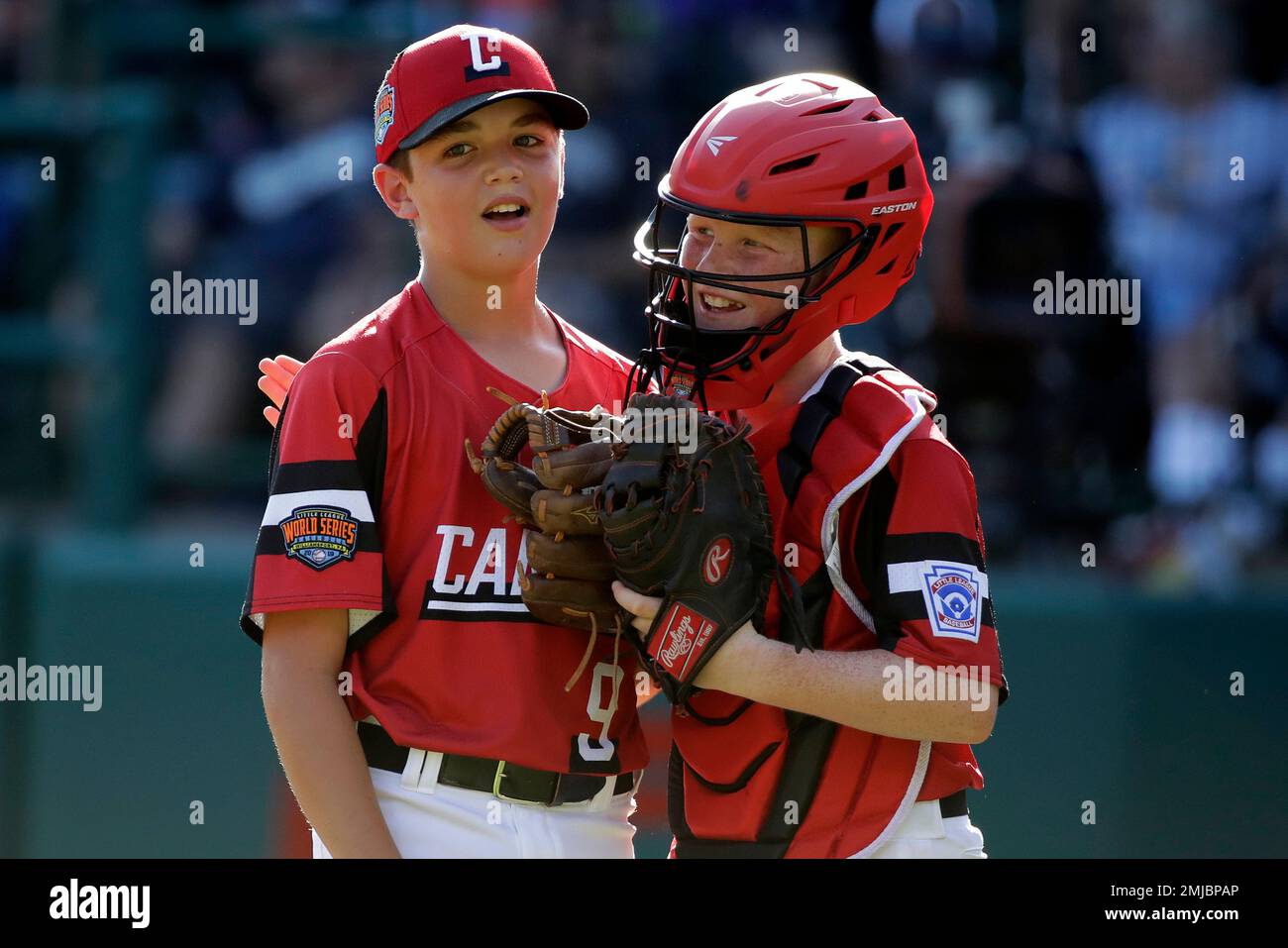 Canada's starting pitcher Timmy Piasentin (9) gets hug from catcher ...