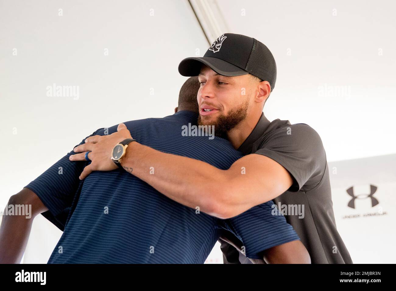 Golden State Warriors guard Stephen Curry, right, hugs Howard ...