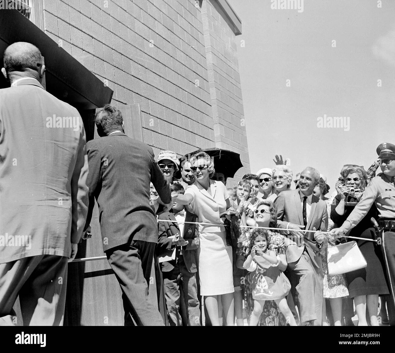 President John F. Kennedy greets parishioners as he enters Sacred Heart ...