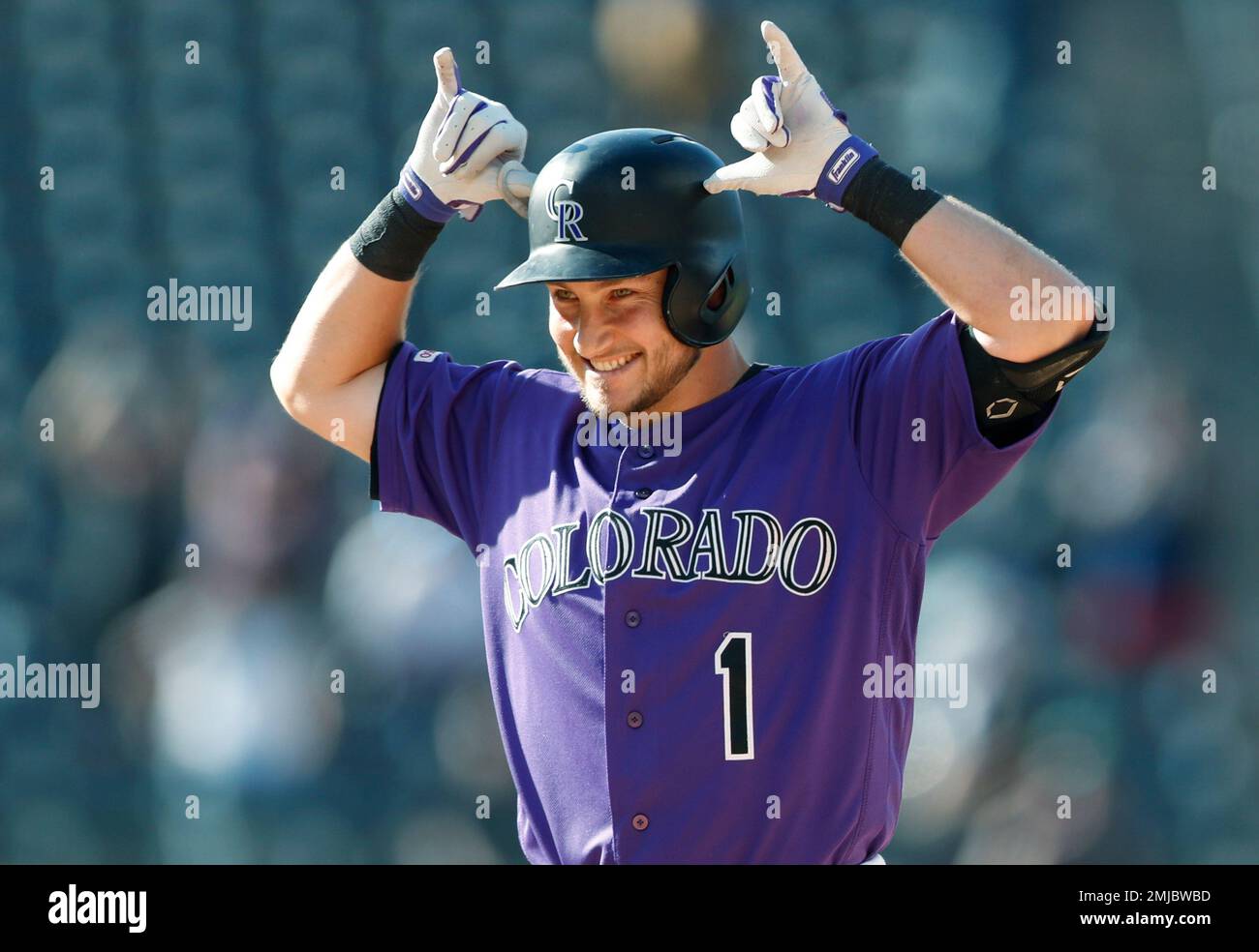 Colorado Rockies' Garrett Hampson gestures to the dugout after his ...