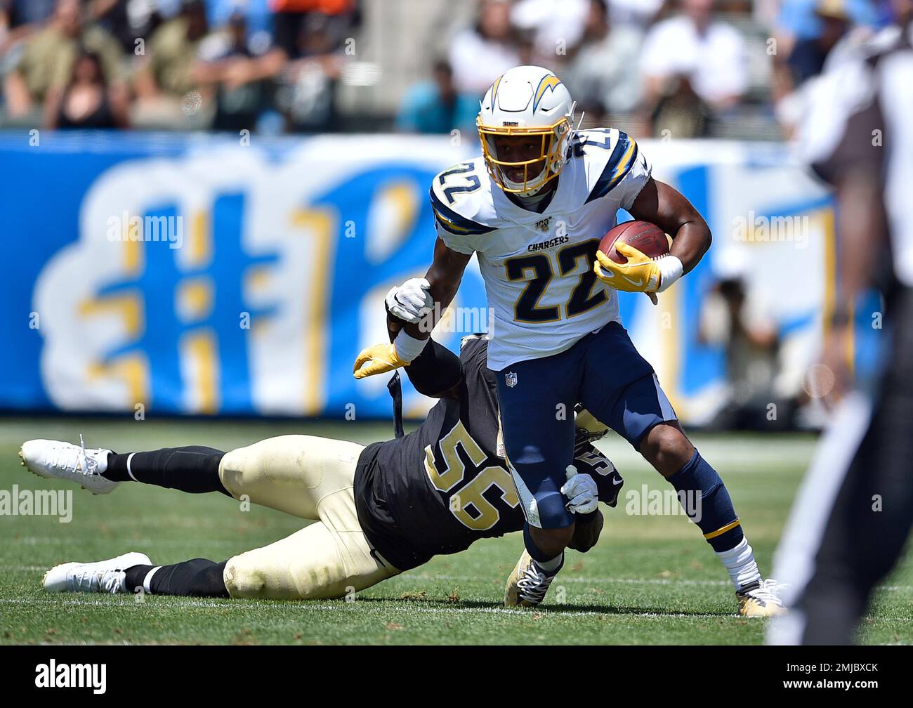 Los Angeles Chargers running back Justin Jackson, right, is tackled by New Orleans Saints ...