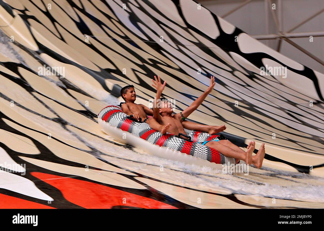 People escape the searing summer heat at a water park in Baghdad, Iraq ...