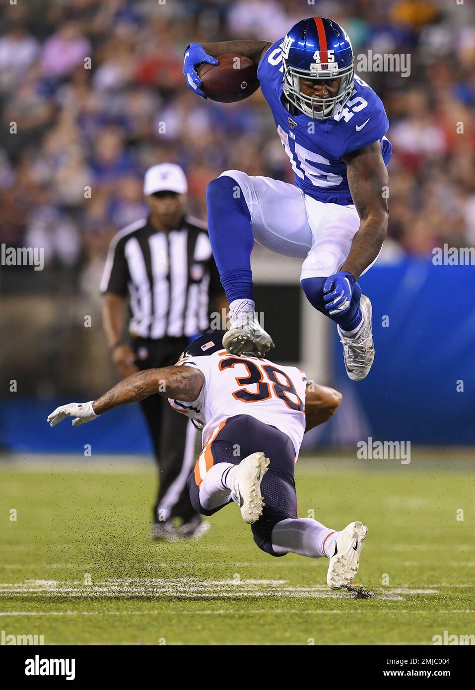 New York Giants running back Rod Smith (45) leaps to avoid a tackle by ...
