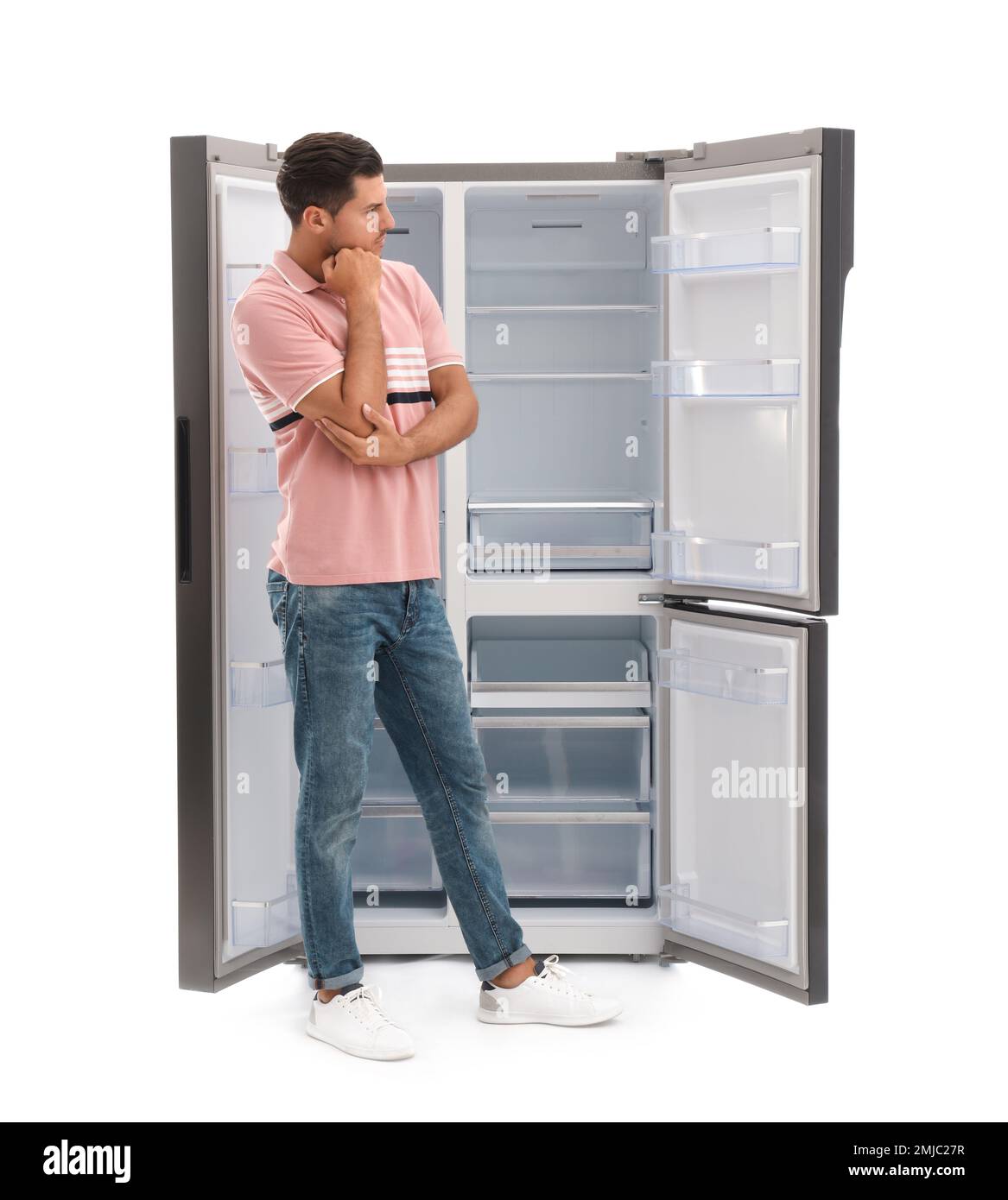 Man near empty refrigerator on white background Stock Photo - Alamy