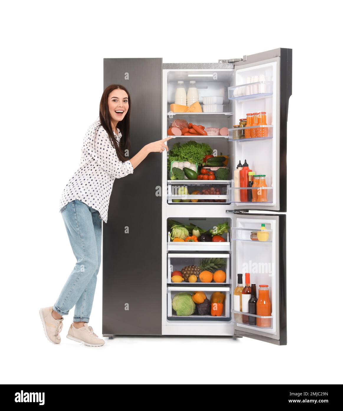 Young woman on fridge Cut Out Stock Images & Pictures - Alamy