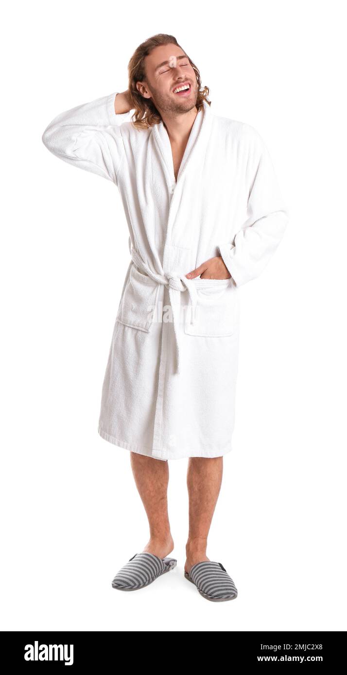 Young man in bathrobe on white background Stock Photo - Alamy