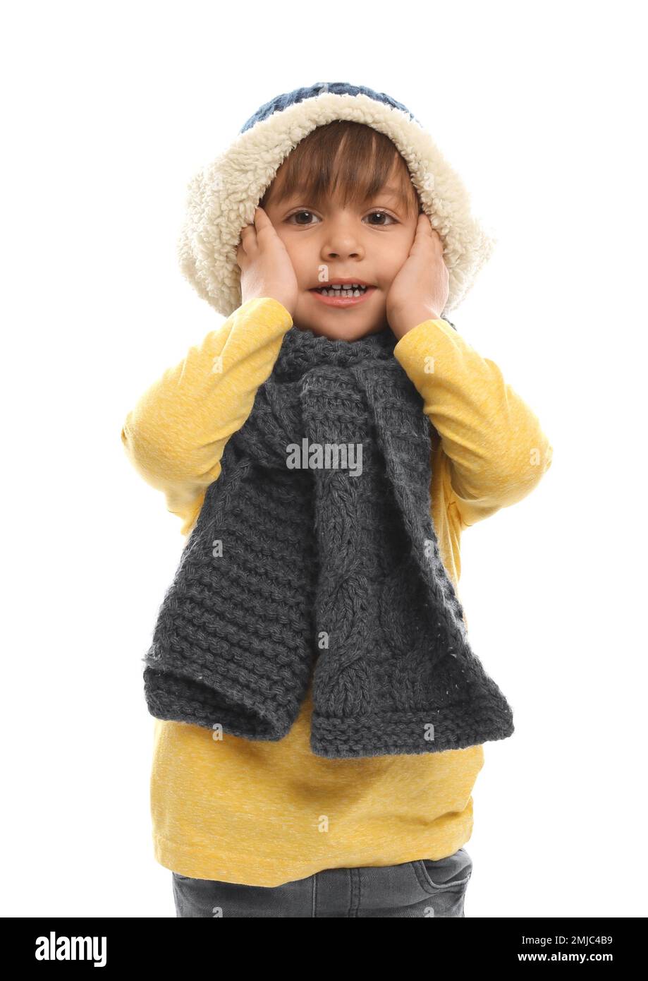 Cute little boy in warm clothes on white background. Winter vacation ...