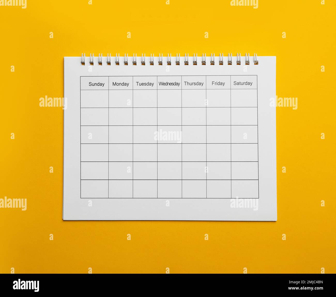 Blank calendar on yellow background, top view Stock Photo - Alamy