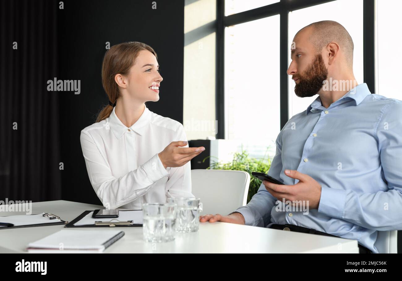 Business people talking at white table in conference room Stock Photo ...