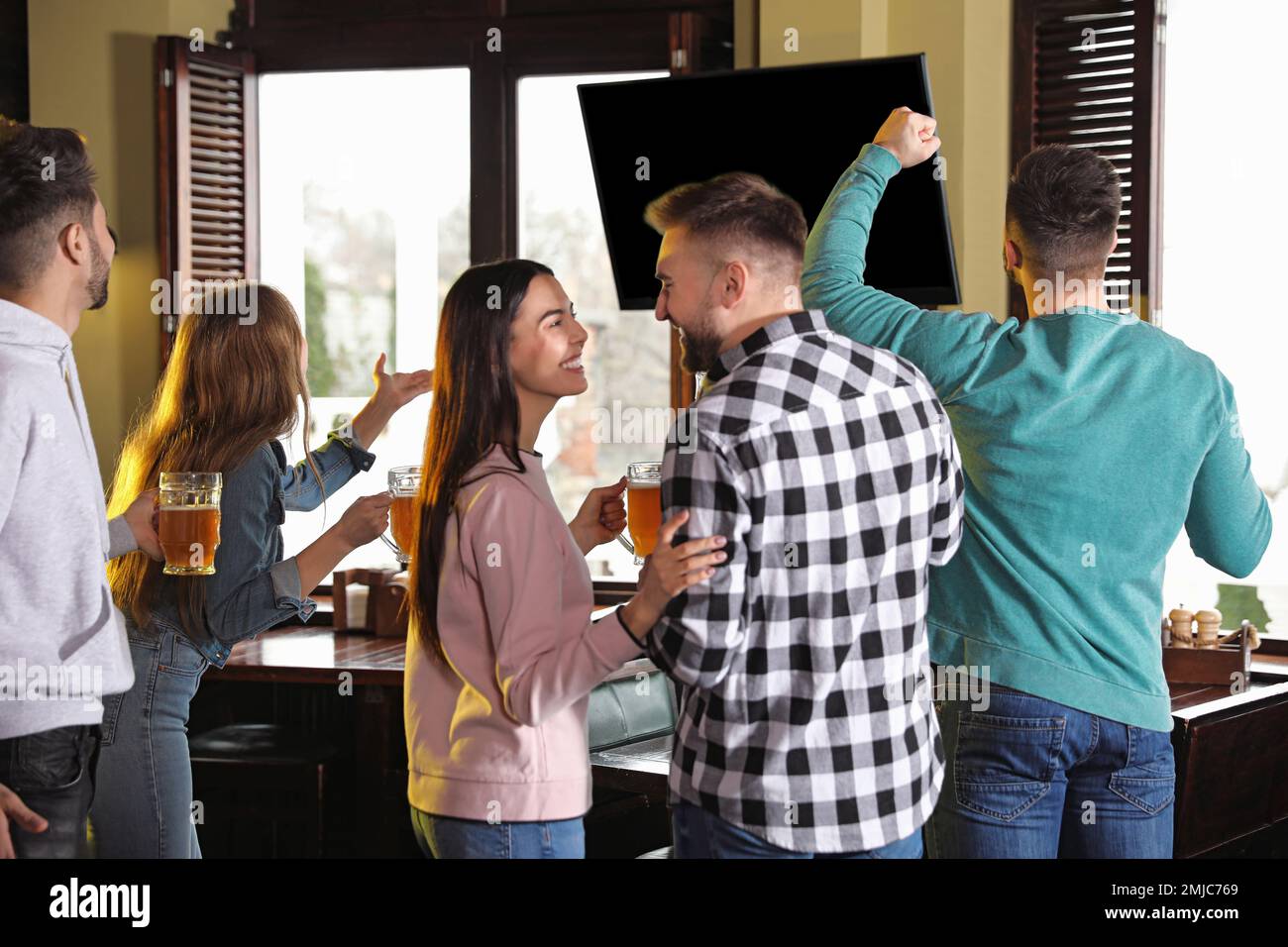 Group of football fans in sport bar Stock Photo - Alamy