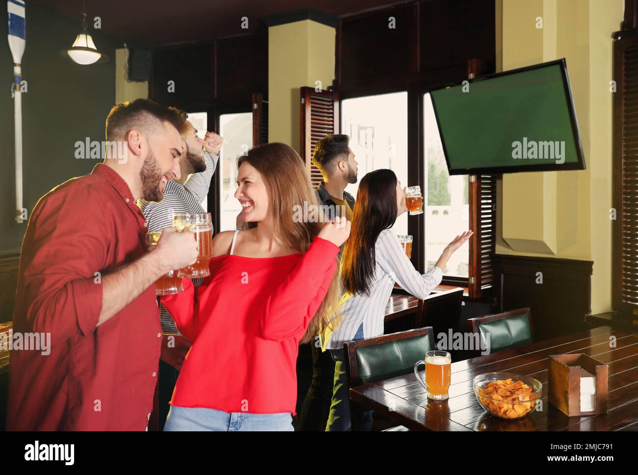 Group of football fans in sport bar Stock Photo - Alamy