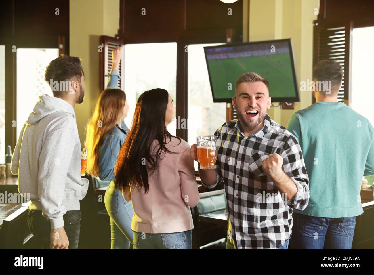 Group of football fans in sport bar Stock Photo - Alamy