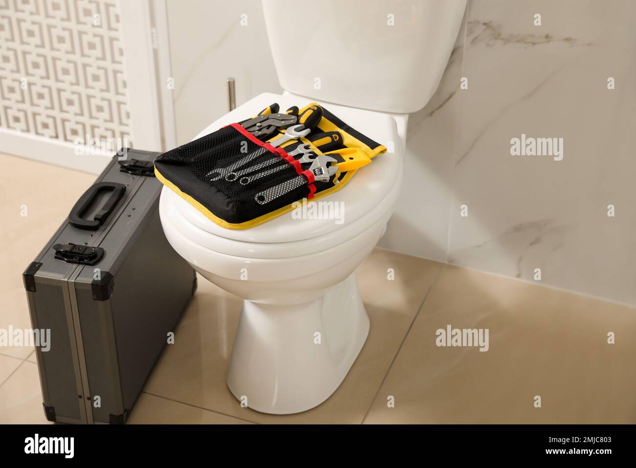 Plumber's tools on toilet bowl in bathroom Stock Photo - Alamy