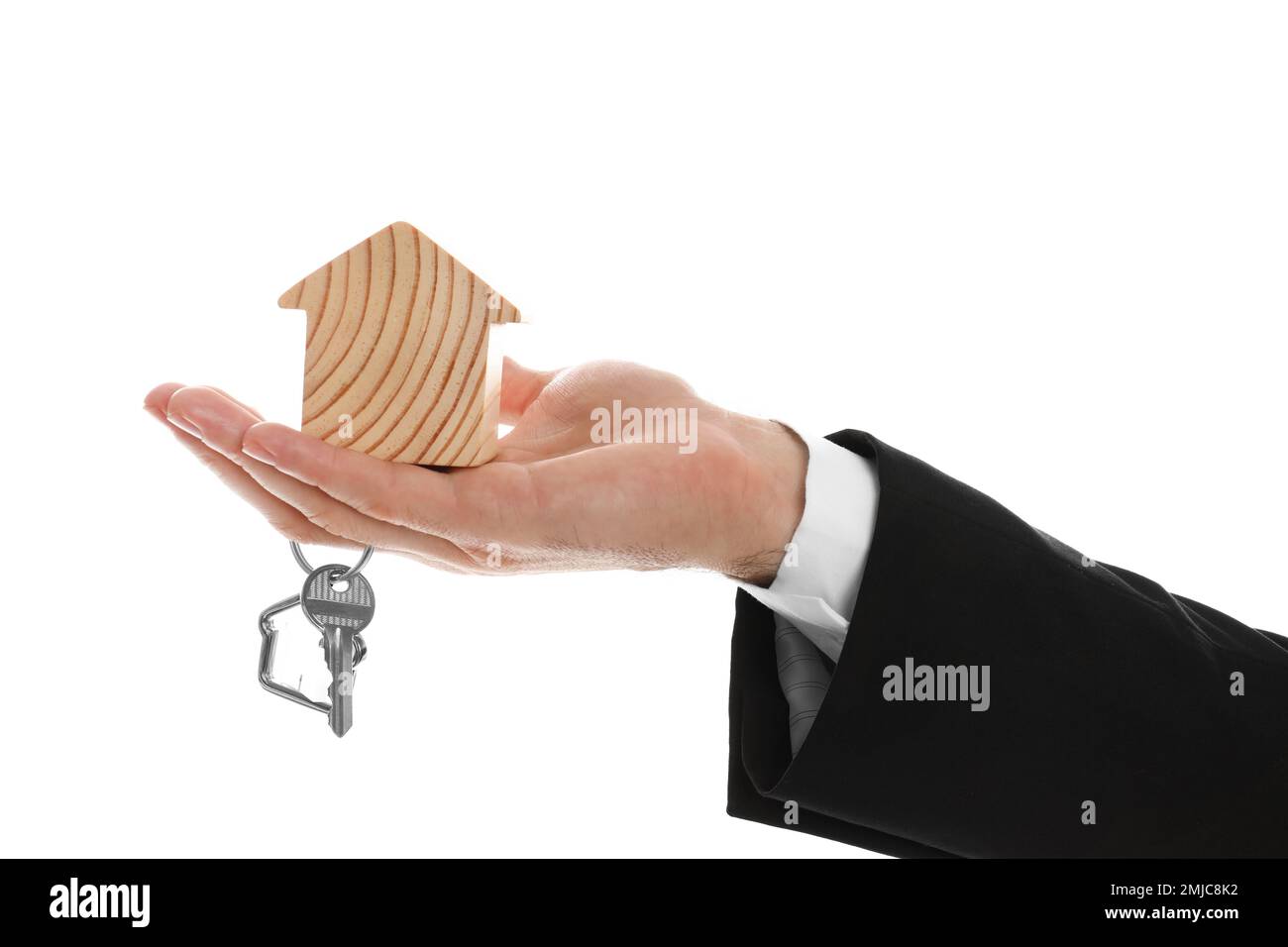 Real estate agent holding house figure and key on white background ...