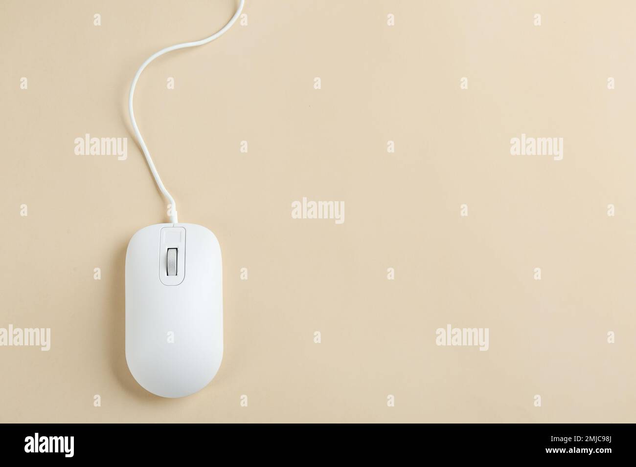 Modern wired optical mouse on beige background, top view. Space for ...
