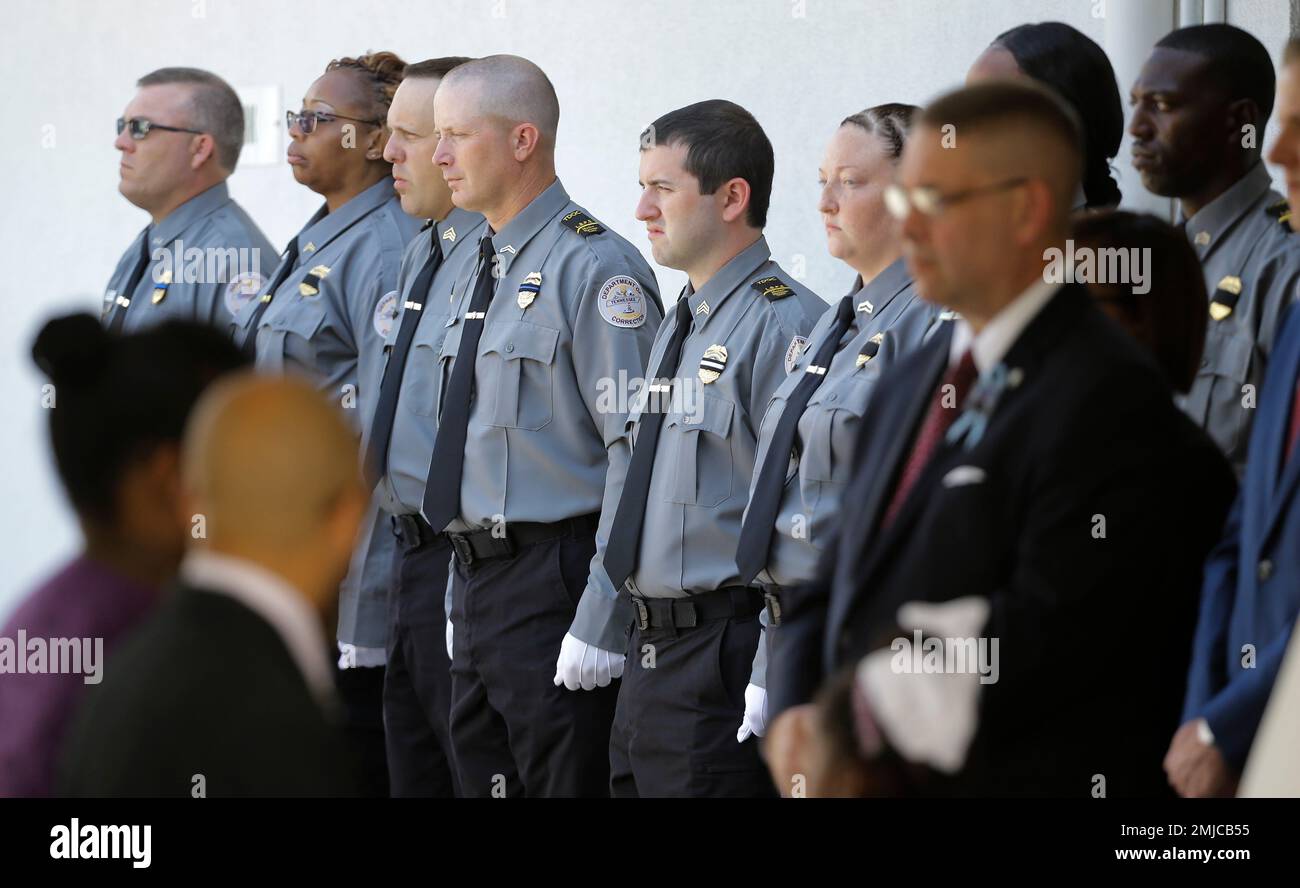 Tennessee Department of Correction guards stand by a church door as ...