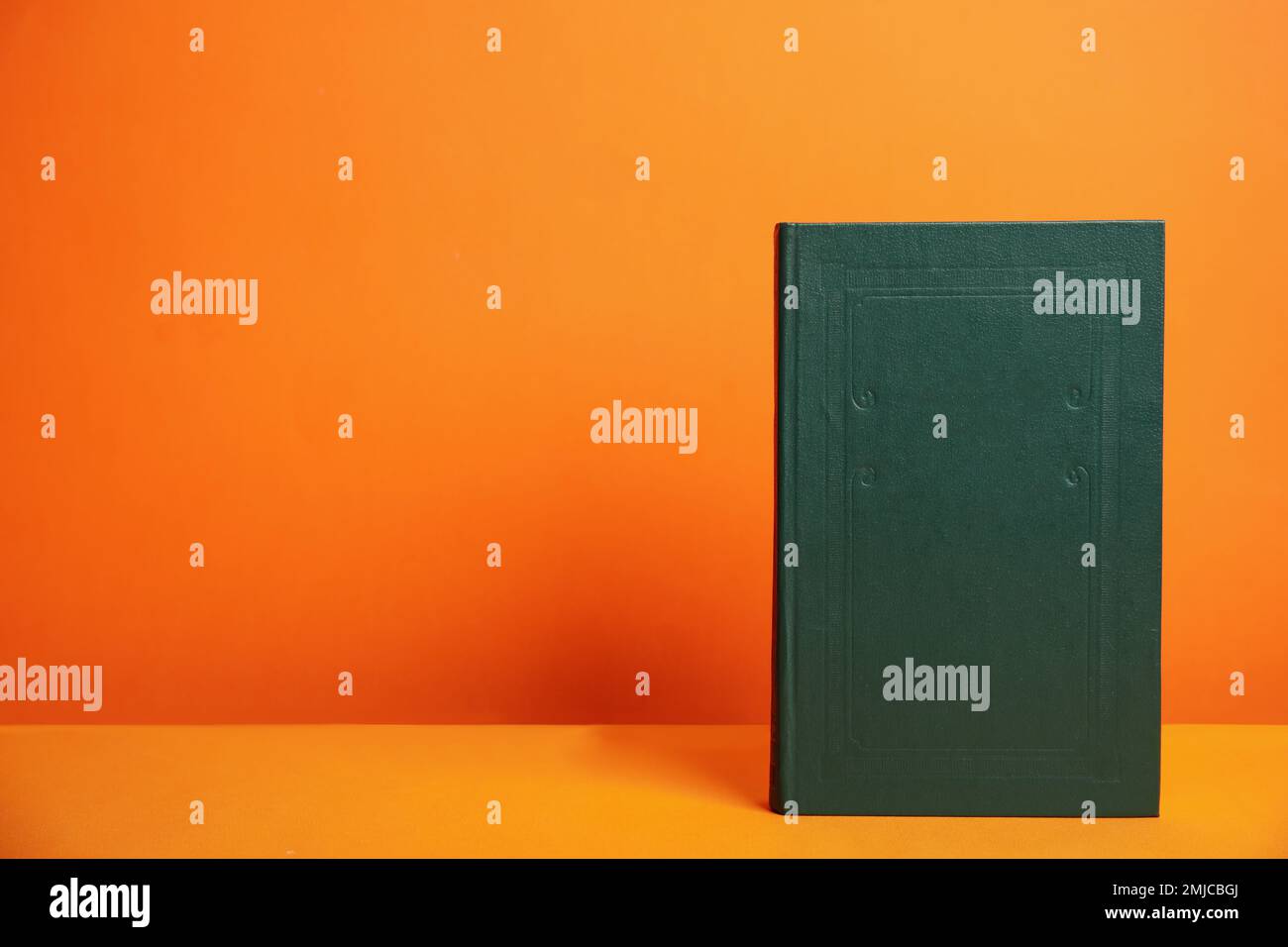 Hardcover book on orange background. Space for design Stock Photo - Alamy